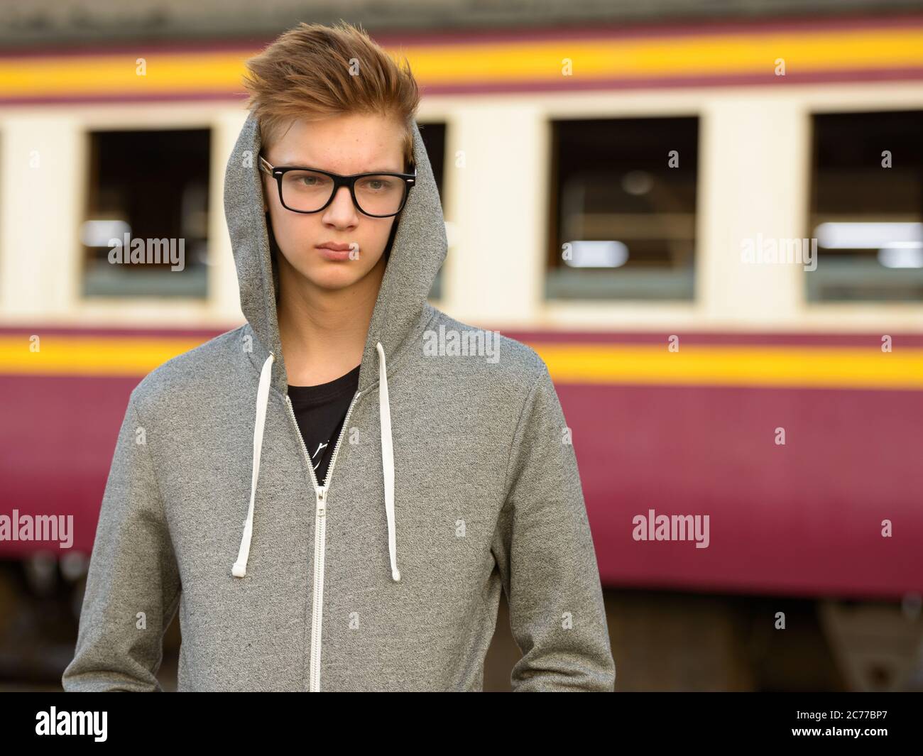 Young handsome teenage boy at the railway train station Stock Photo - Alamy
