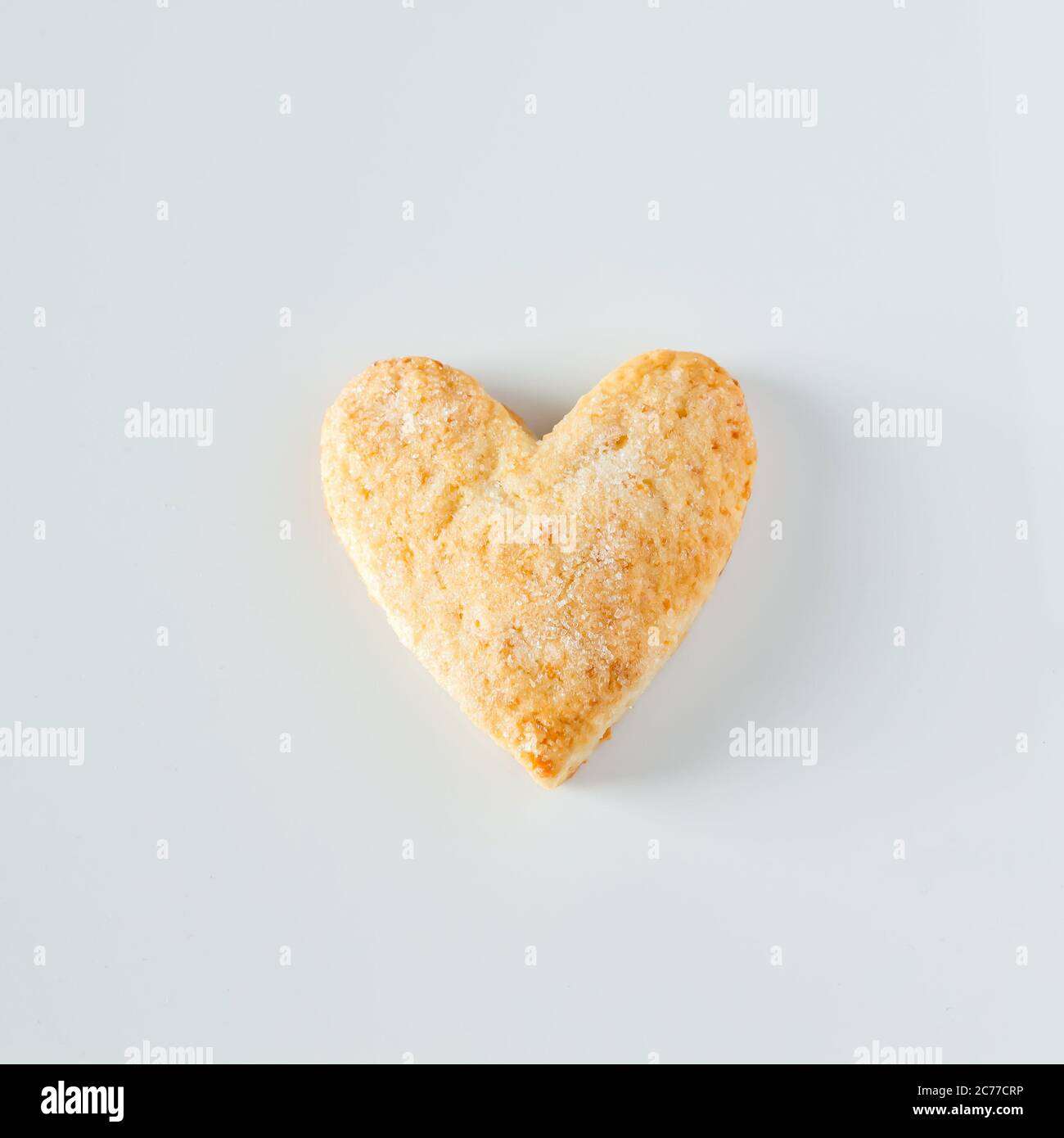 One heart shaped cookie on a white background. One heart shaped sugar ...