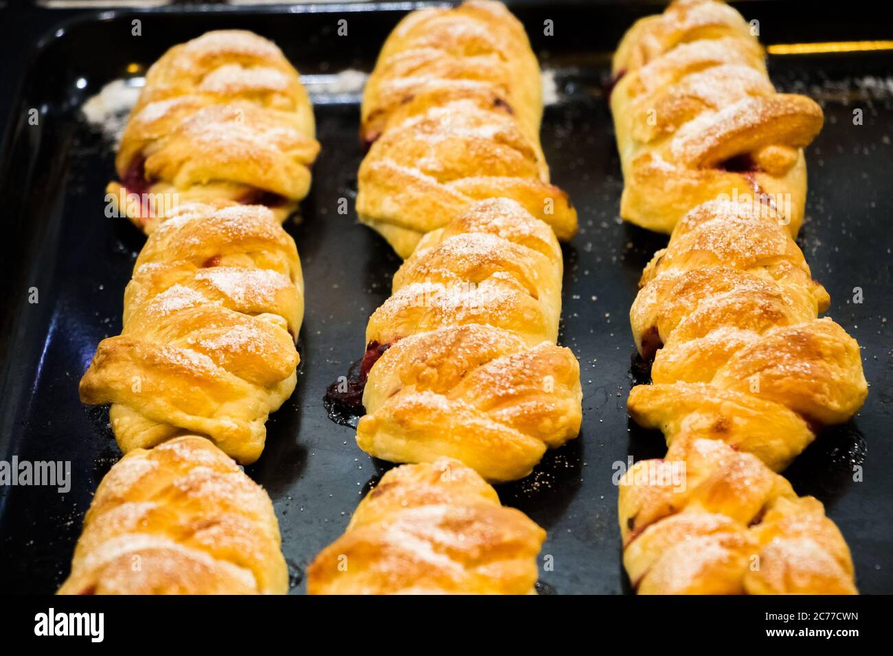 Croissants made of puff pastry stuffed with dark gooseberries Stock ...