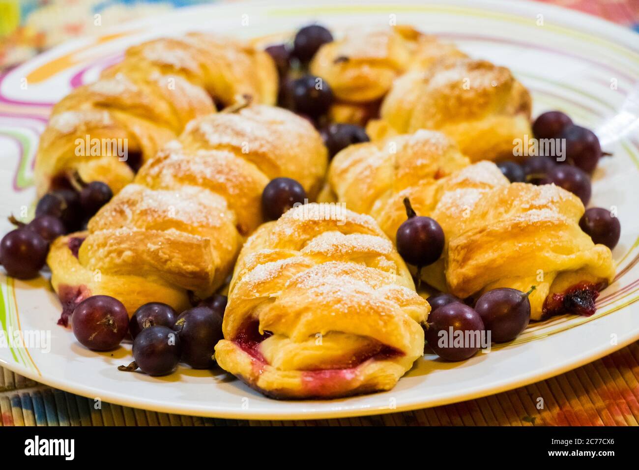 Croissants made of puff pastry stuffed with dark gooseberries Stock ...