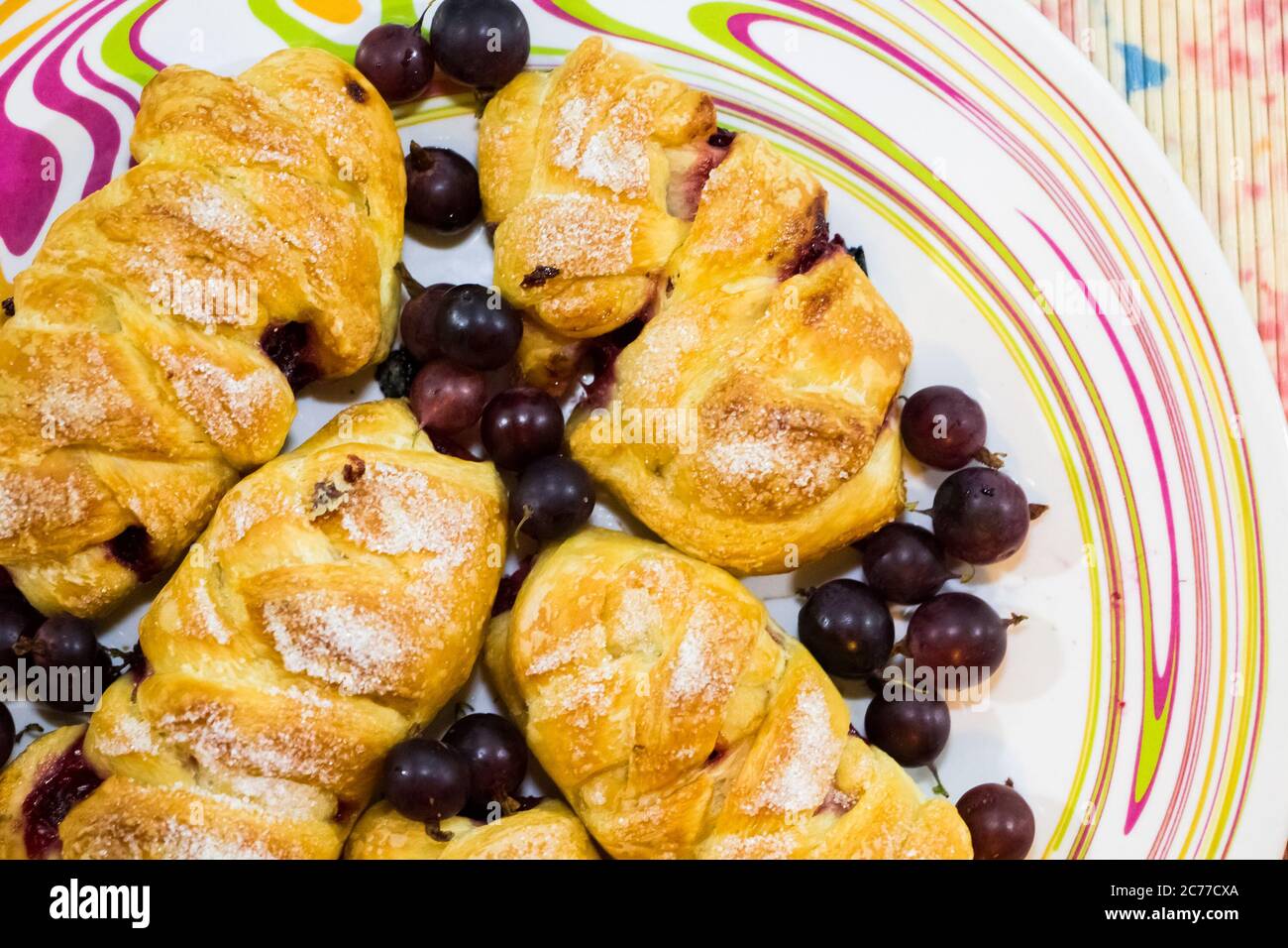 Croissants made of puff pastry stuffed with dark gooseberries Stock ...
