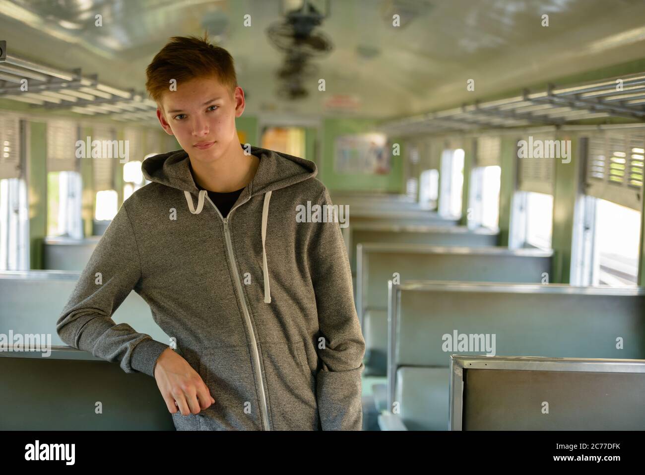 Young handsome teenage boy at the railway train station Stock Photo - Alamy