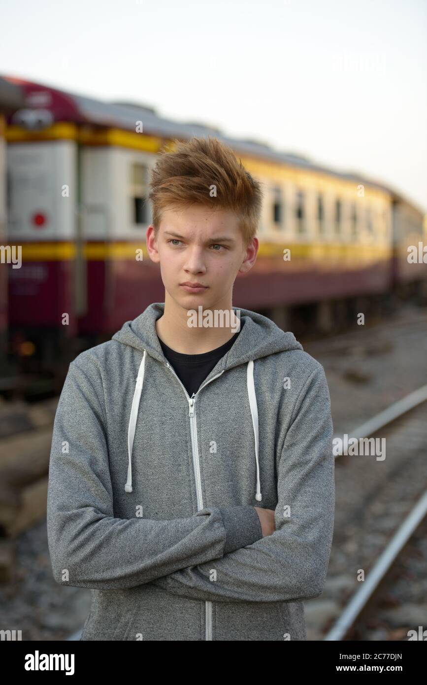 Young handsome teenage boy at the railway train station Stock Photo - Alamy