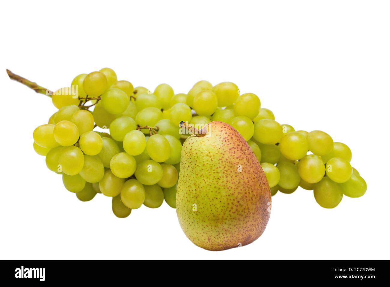 Bunch of ripe green grapes and a juicy pear isolated on white ...
