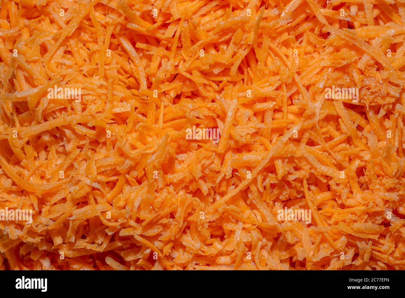 Grated carrots closeup. Background from shredded orange vegetables ...