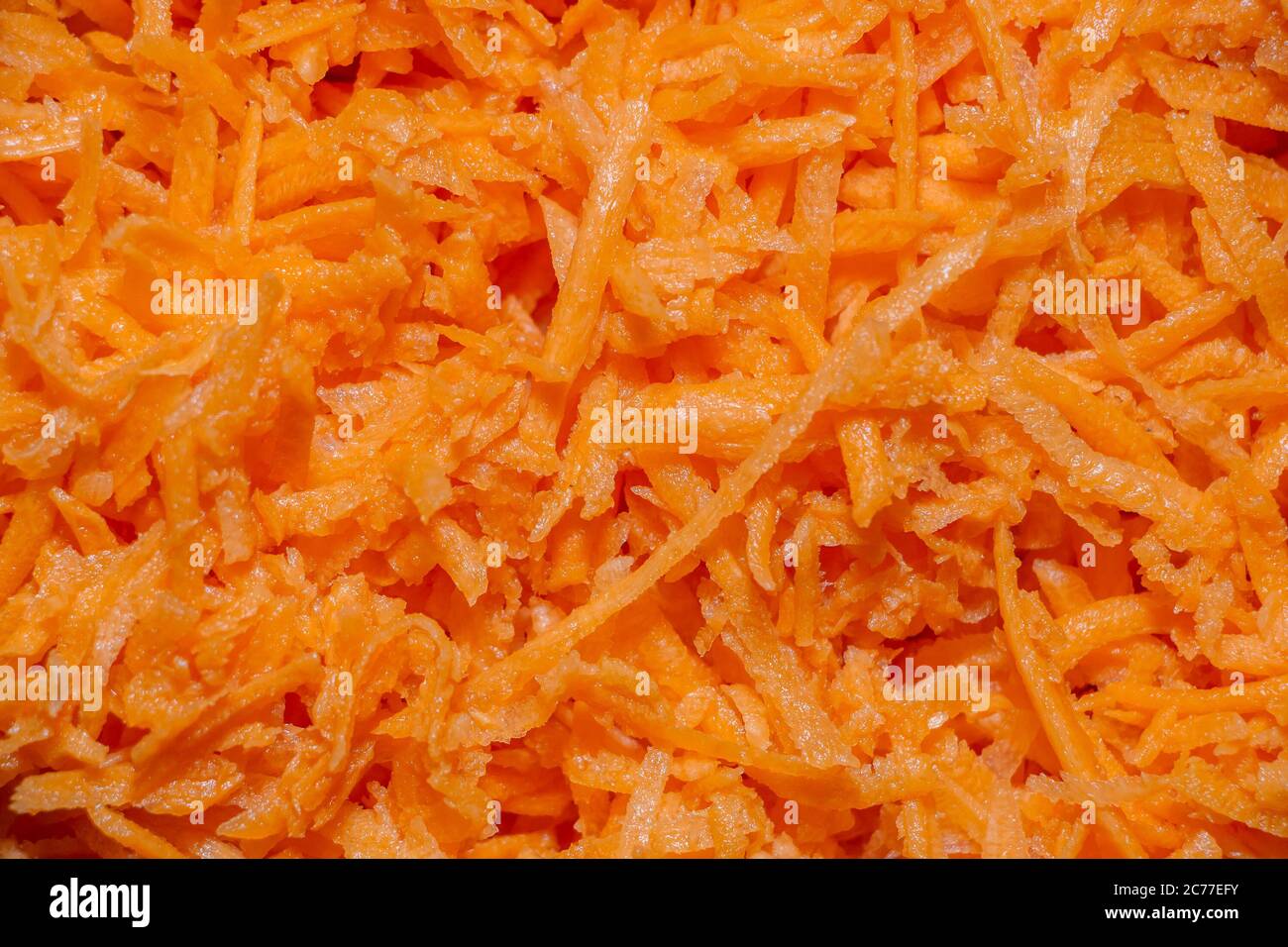 Grated carrots closeup. Background from shredded orange vegetables ...