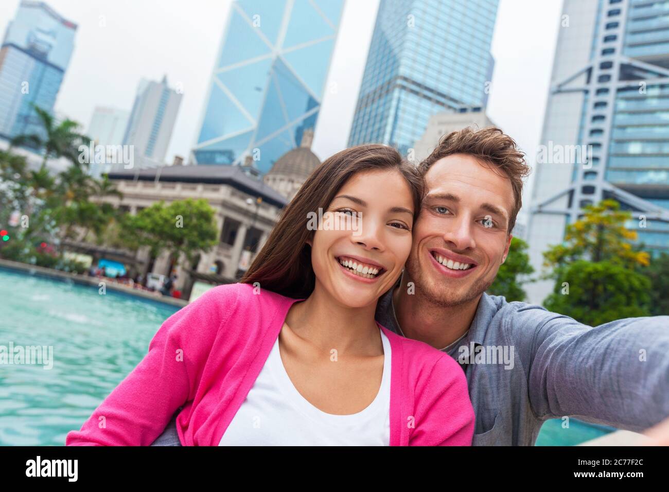 Selfie tourists couple Asian woman and Caucasian taking picture with ...