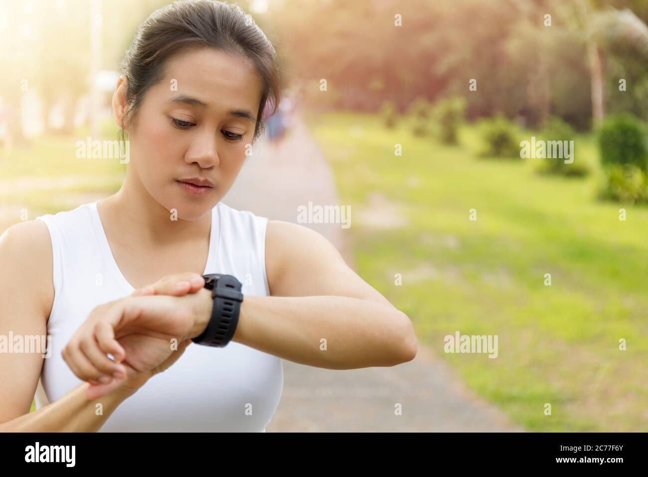 Asian Woman setting up the fitness smart watch for running. young women ...