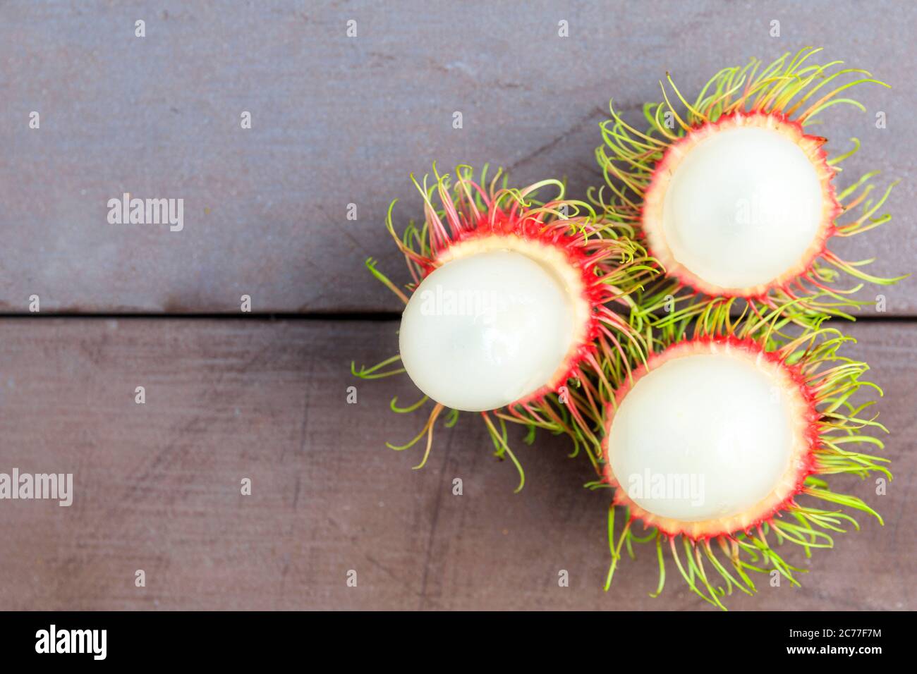 Top view fresh rambutan peeled on wood table . Tropical fruit fresh ...