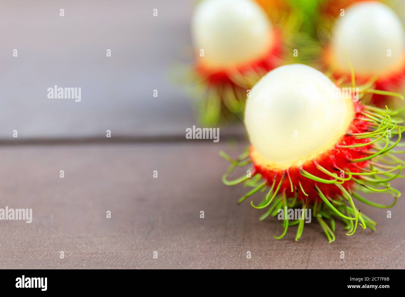 Close up fresh rambutan peeled on wood table with blur rambutan peeled ...