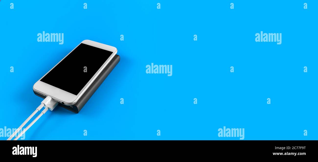 Top view smartphone charging with power bank on blue background with ...