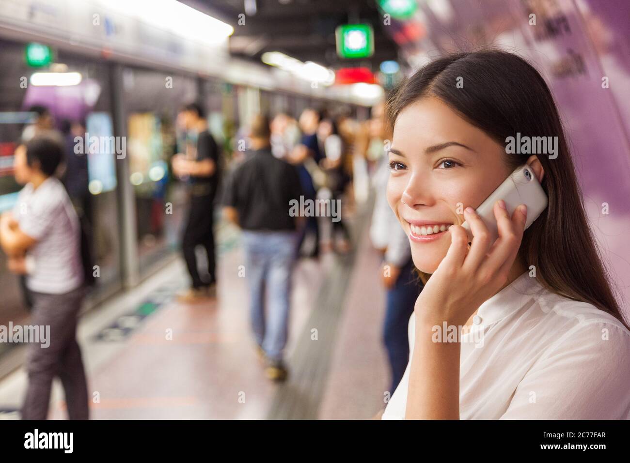 Businesswoman on subway metro commute public transport station talking ...