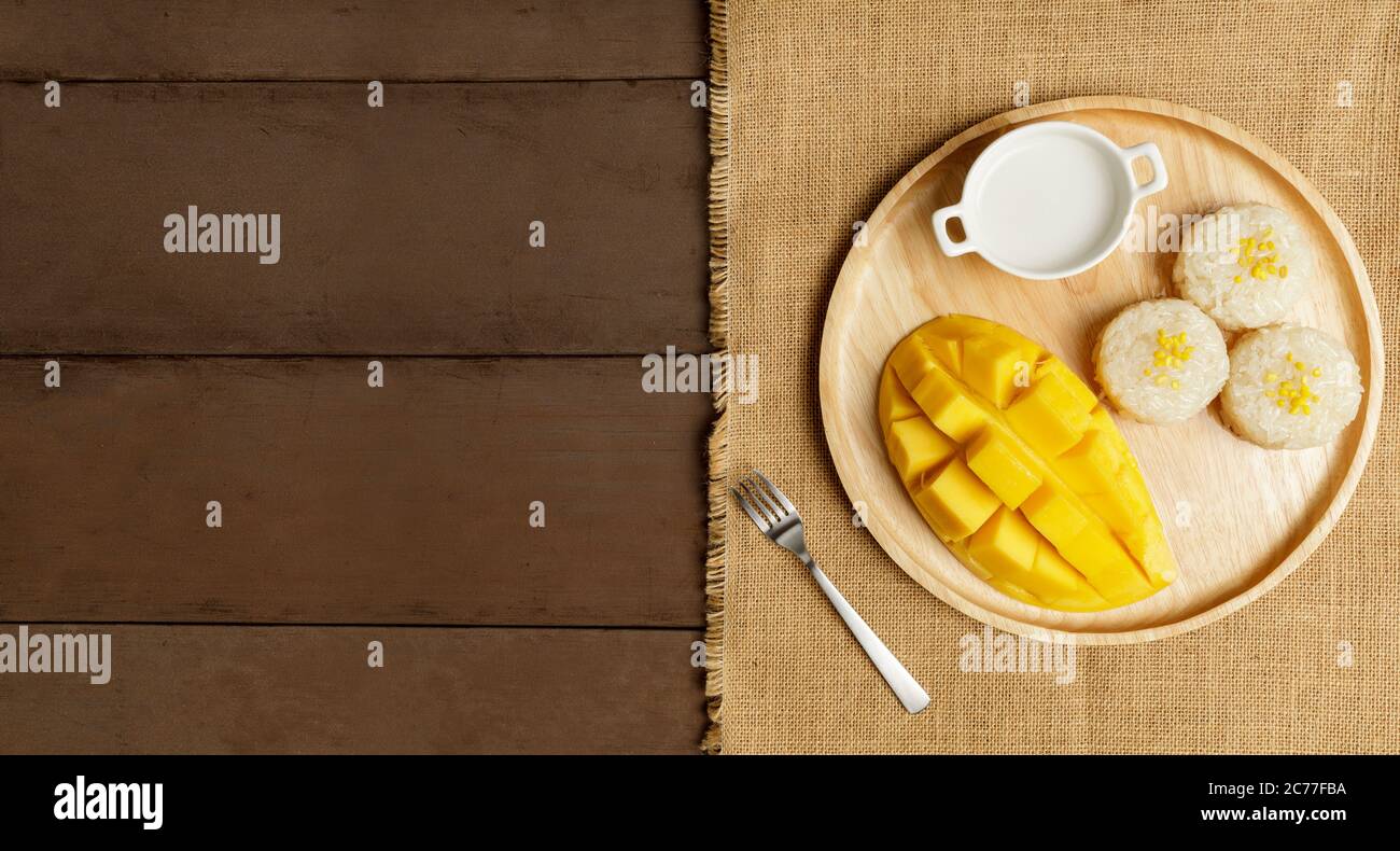Top view Yellow half mango with small fork. Mango fruit cubes on the ...