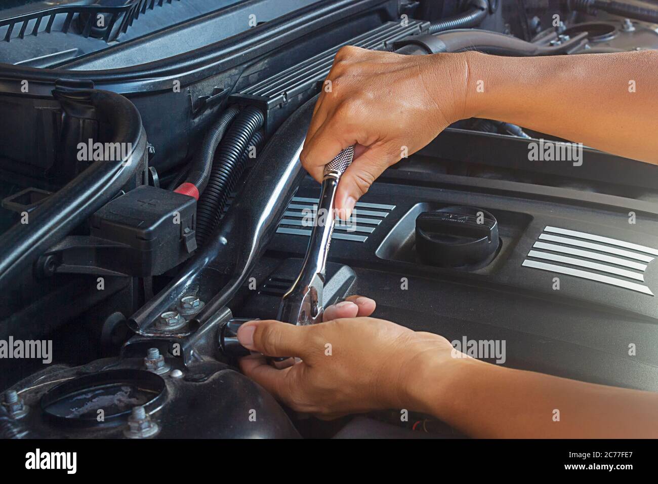 Mechanic working on an engine at the repair car Stock Photo - Alamy