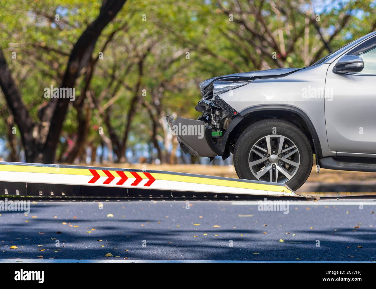accident Car Slide on truck for move. Gray car have damage by accident ...