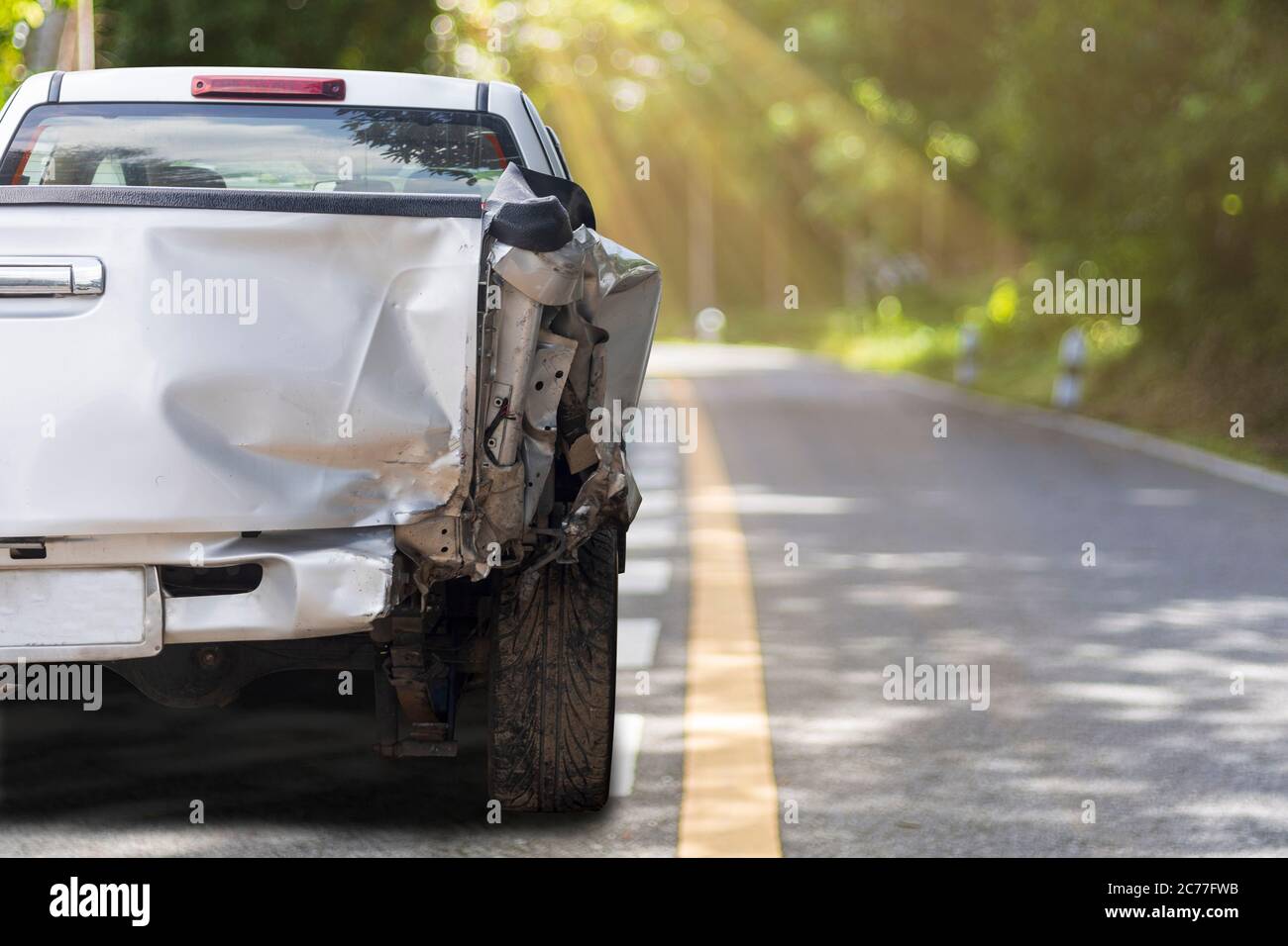 Back of gray color car big damaged and broken by accident on road ...