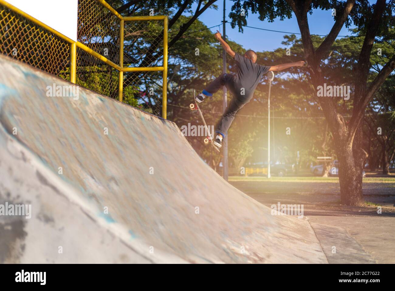 Young boy jump on ramp with skateboard outdoor Stock Photo - Alamy