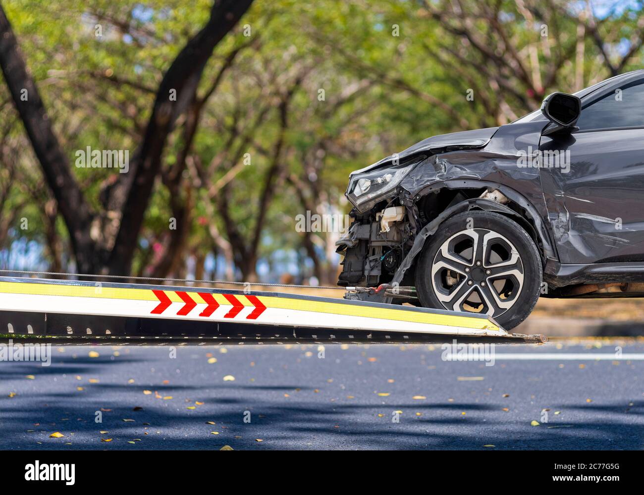 accident Car Slide on truck for move. Balck car have damage by accident ...