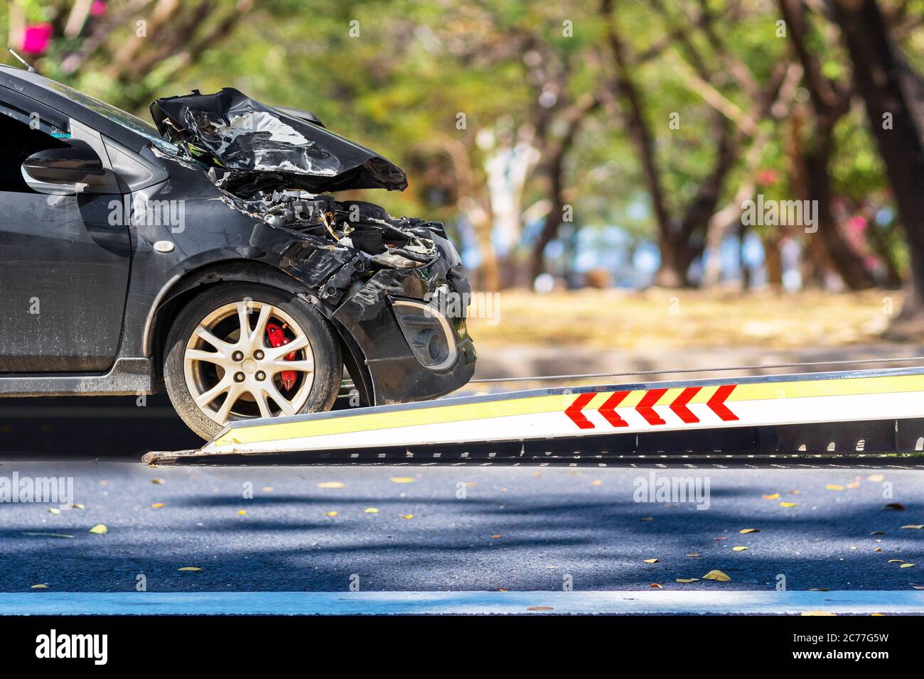accident Car Slide on truck for move. Black car have damage by accident ...
