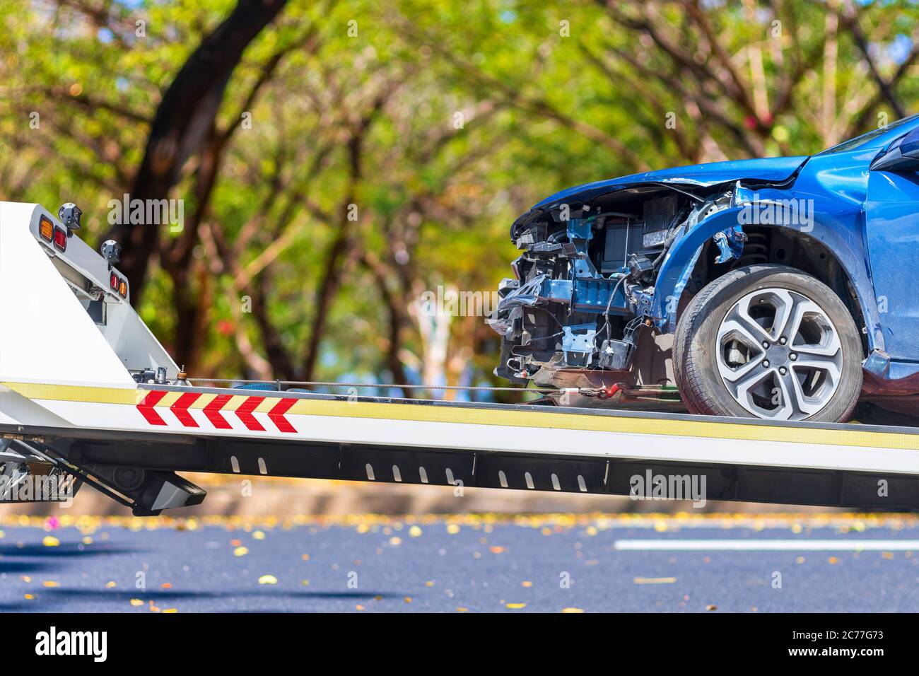 accident Car Slide on truck for move. Blue car have damage by accident ...