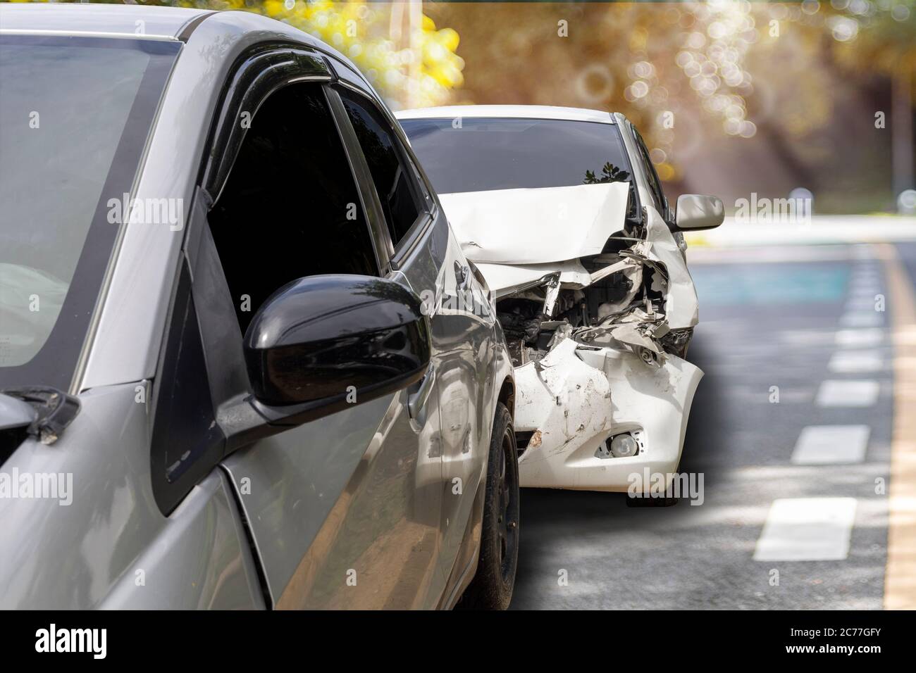 Front of white color car crash with back side of gray color car damaged ...