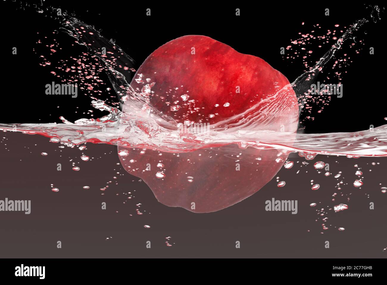 Red apple falling in to water with splash isolate on black background ...