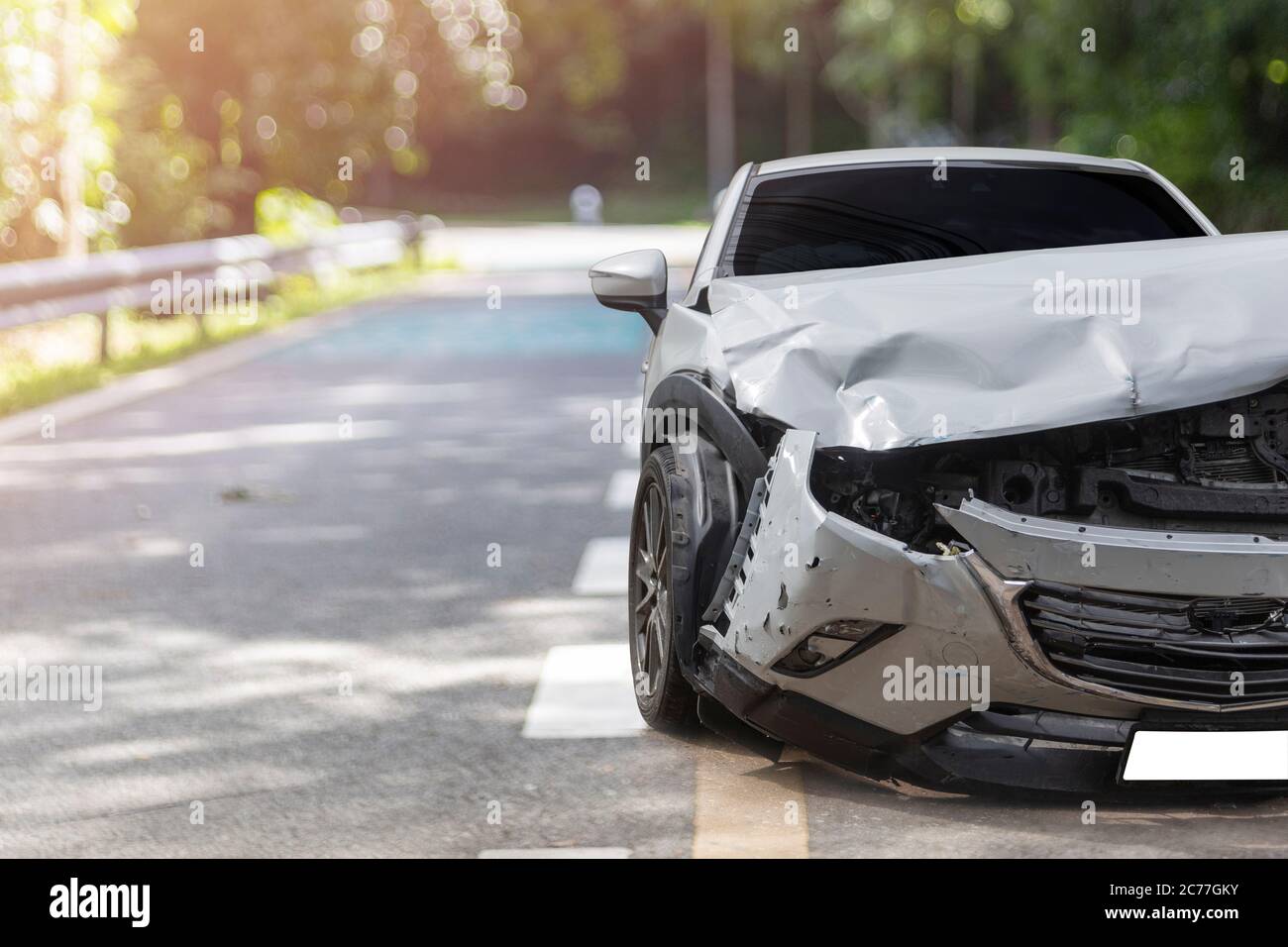 Front of light gray car big damaged and broken by accident on city ...