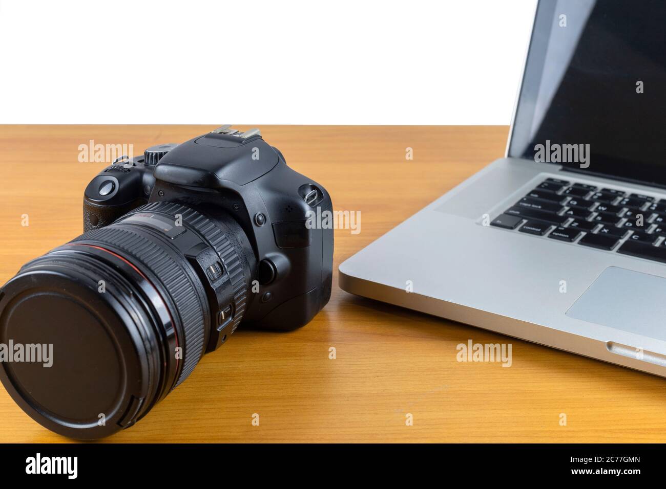 Digital camera and laptop on wood table isolate on white background ...
