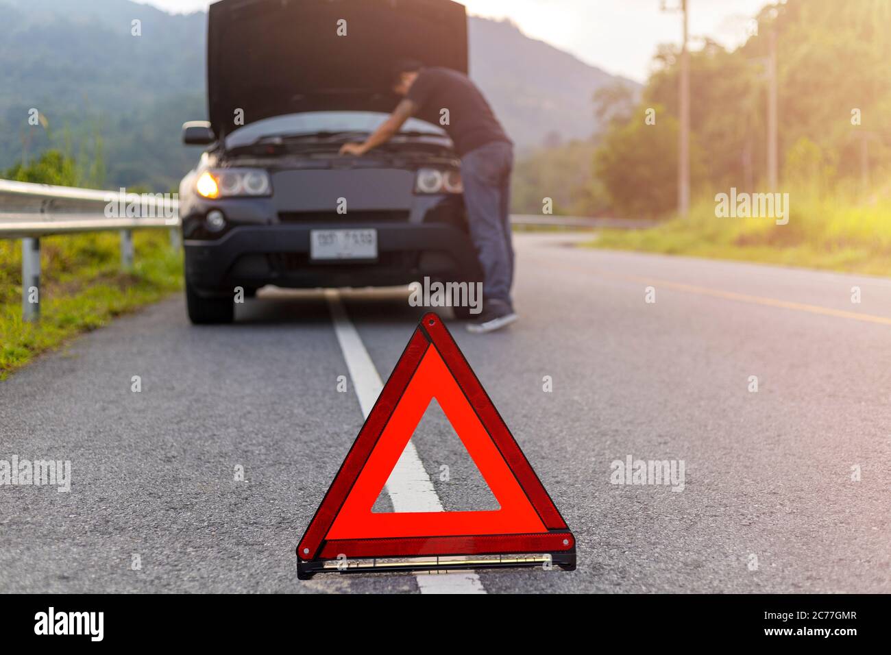 Red triangle sign on road for warning have car with breakdown open car ...