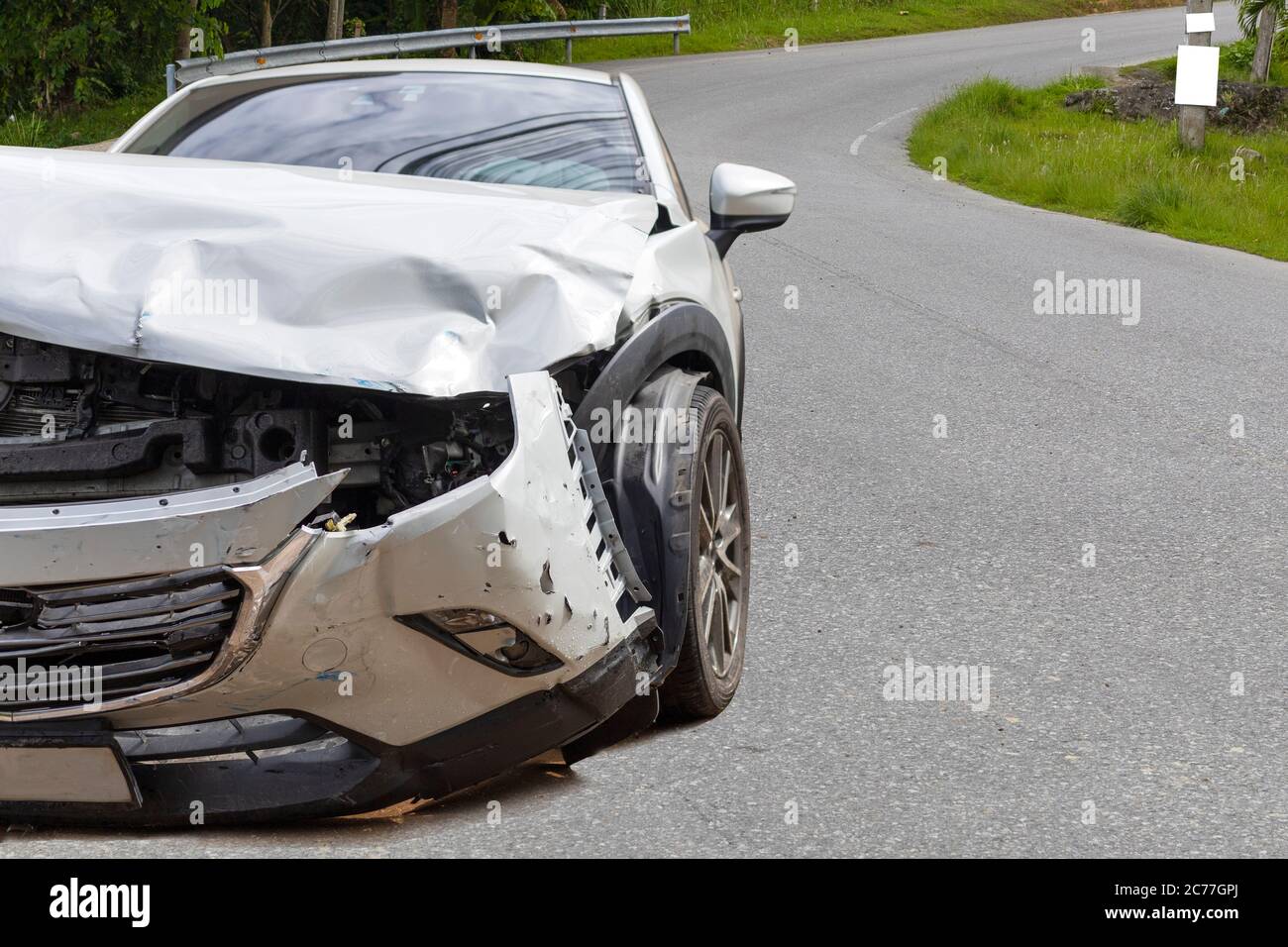 Front of light gray car big damaged and broken by accident on city ...