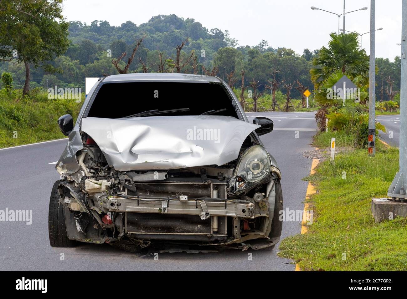 Front of light gray car big damaged and broken by accident on city ...