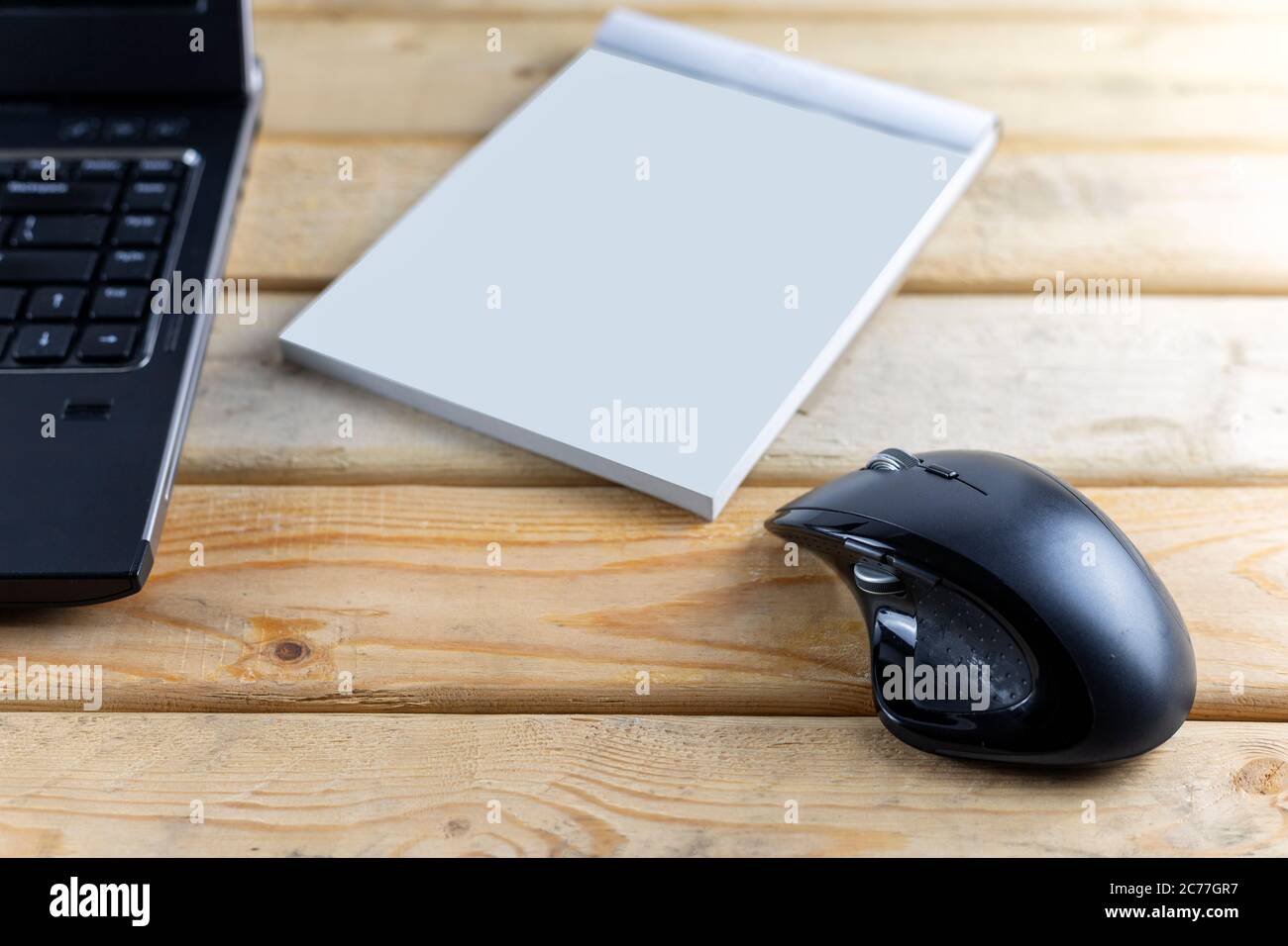 Office desk with mouse, laptop, bill book and pen on wood table . With ...