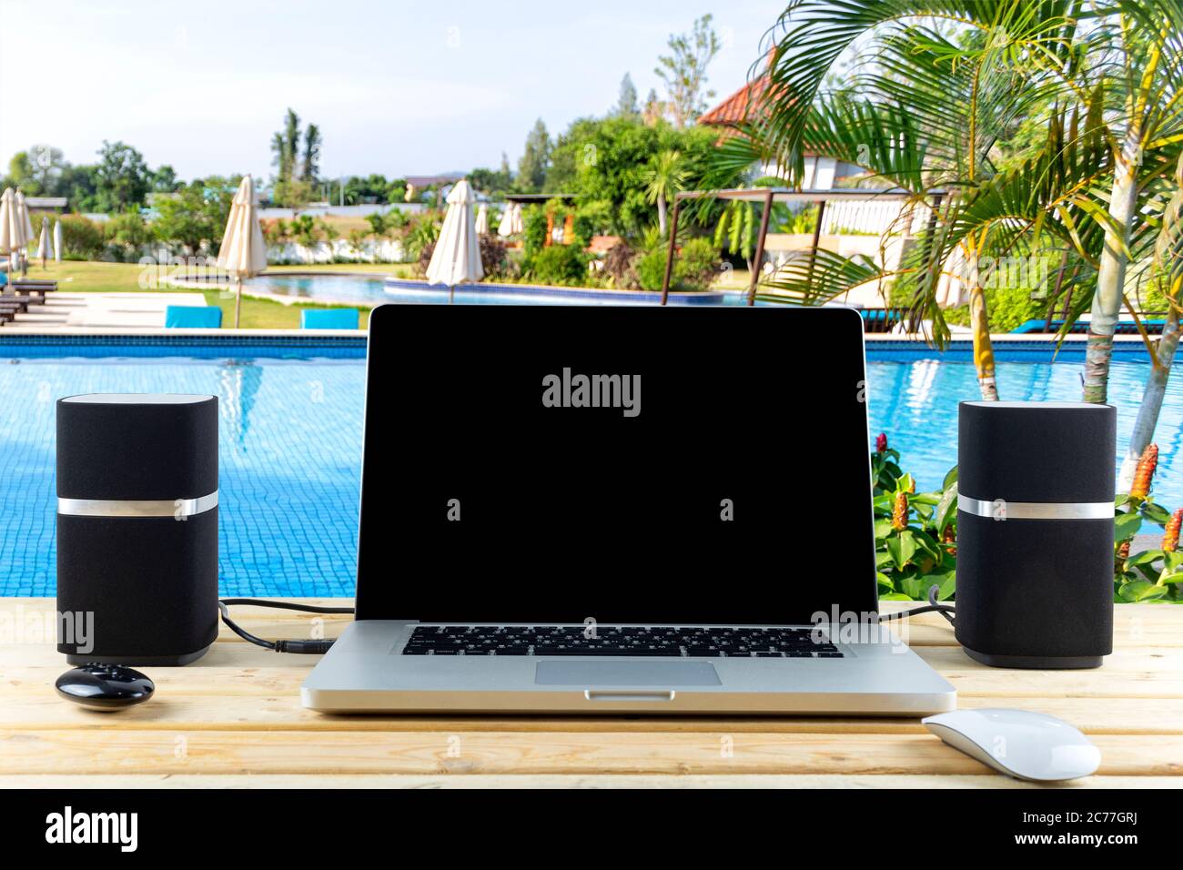 Work desk laptop mouse and speakers on wood table with garden and ...
