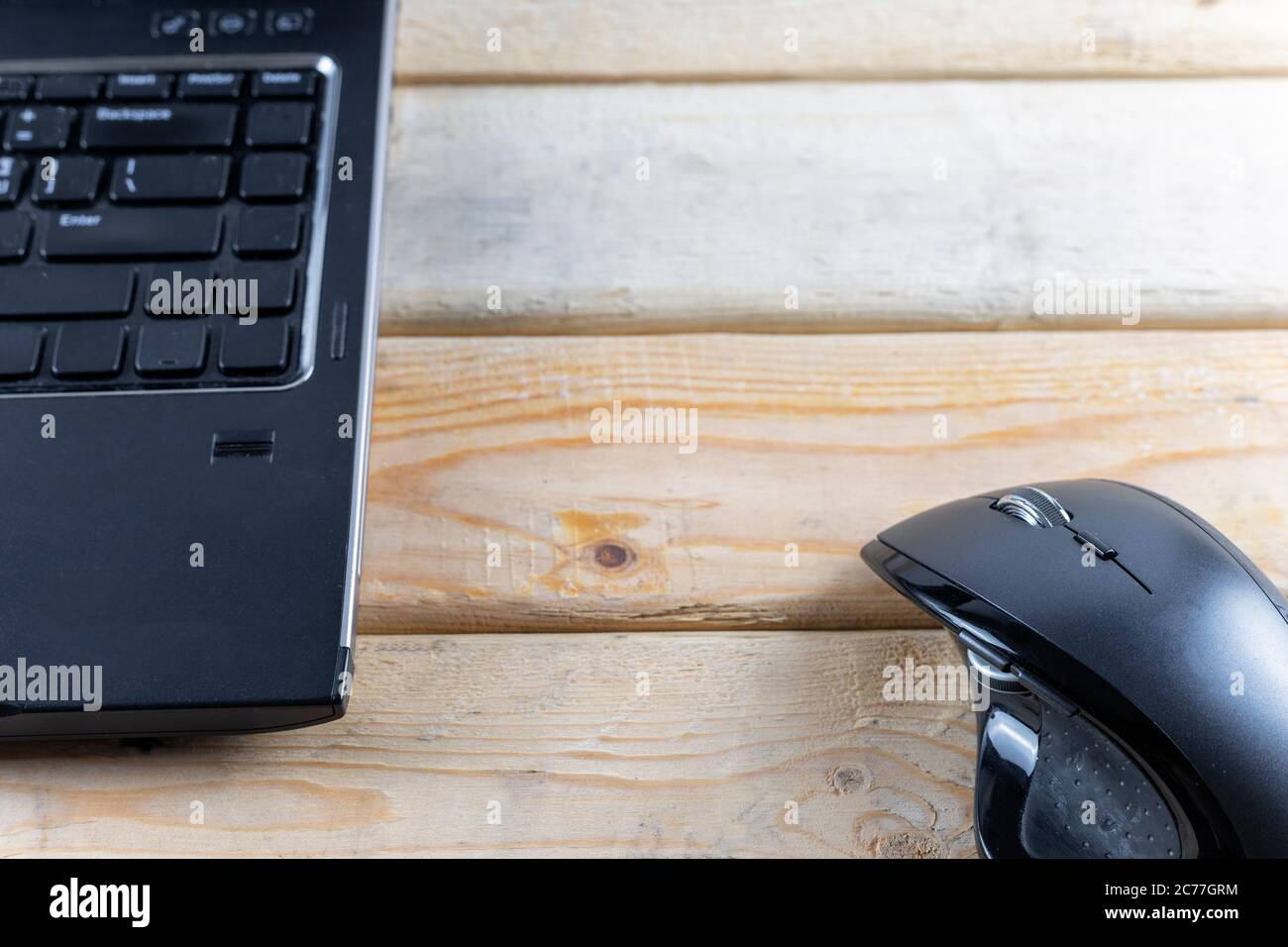 Office concept. Mouse and laptop on wood table. With copy space for ...
