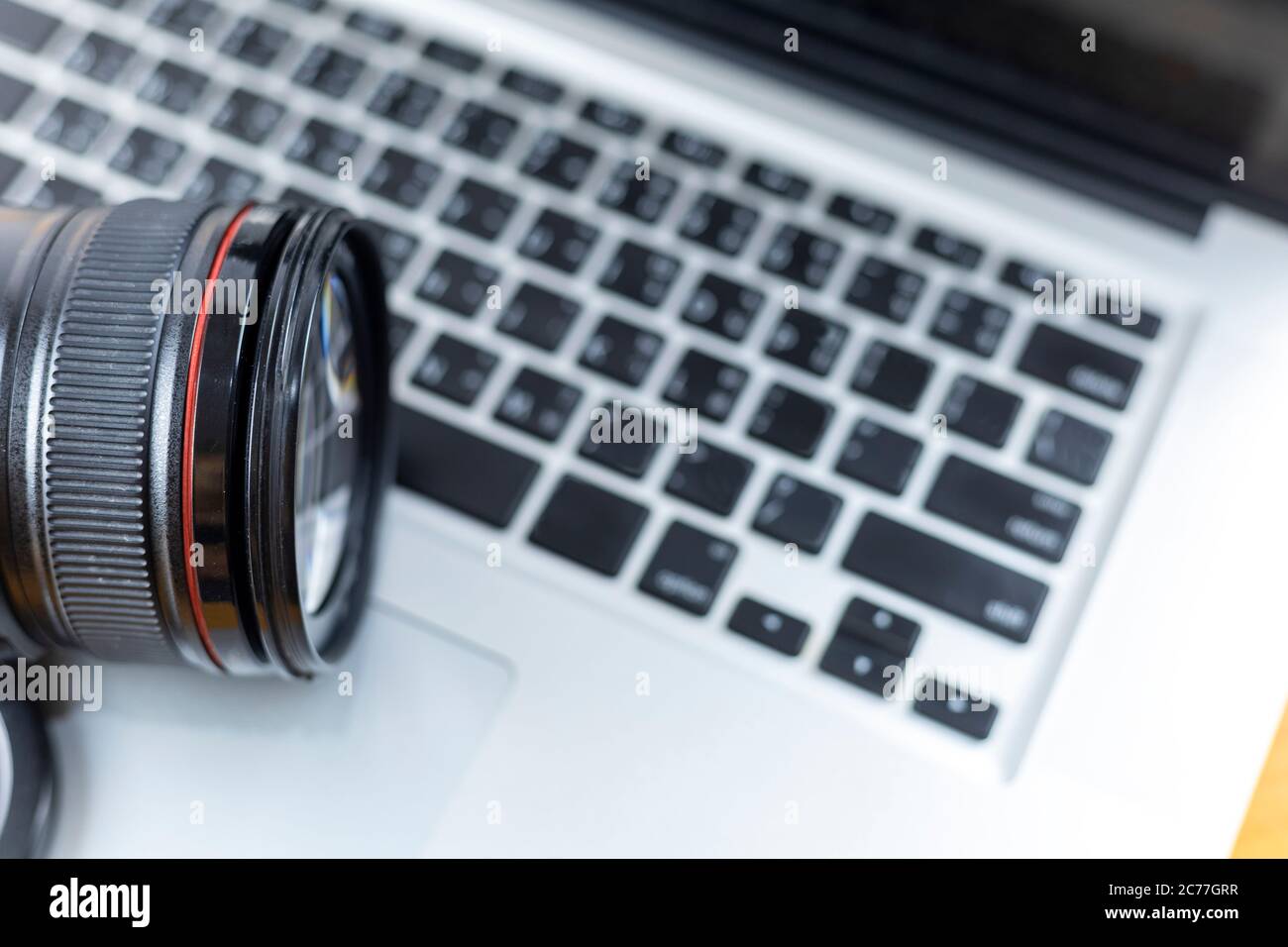 Digital camera len on laptop. Photographic concept Stock Photo - Alamy
