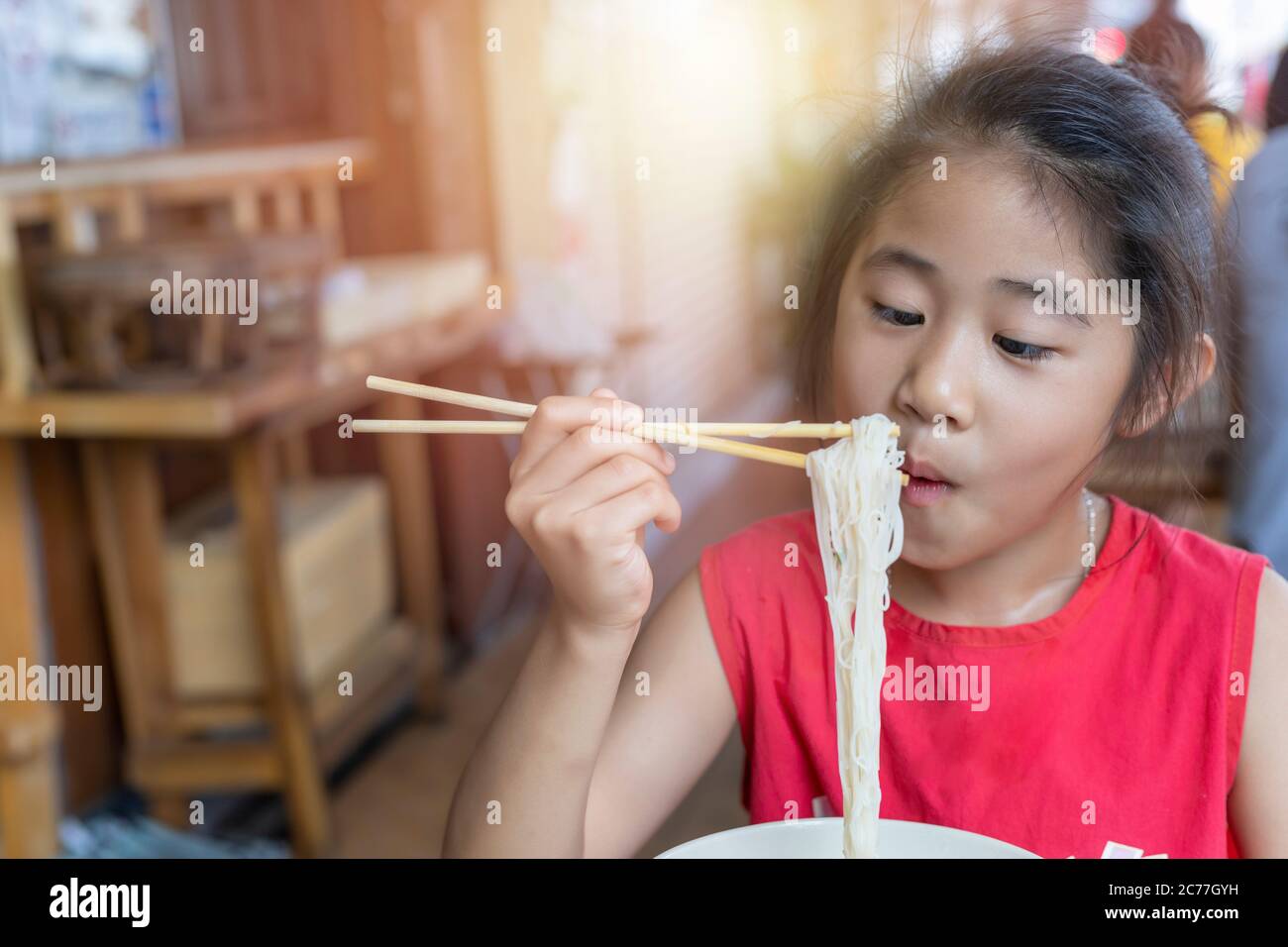 Asian girl eating noodles restaurant hi-res stock photography and ...