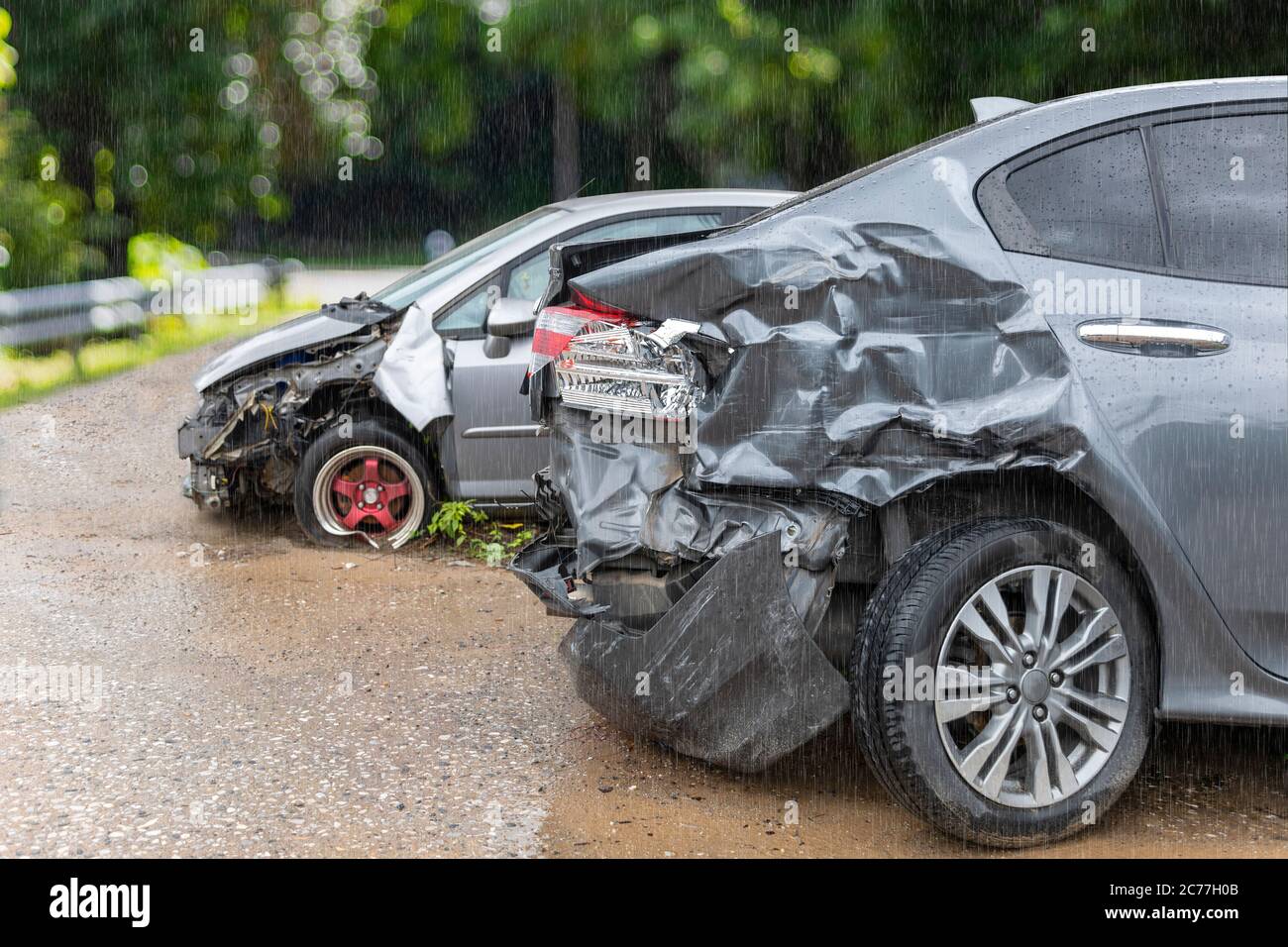 Raining day front of light gray color car crash with back side of gray ...