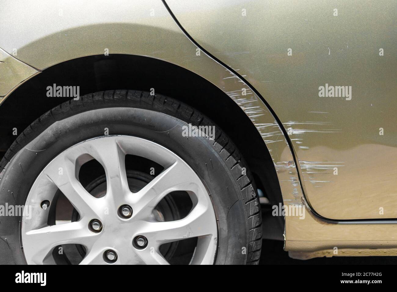 Car crash. Beside the deep green color car have scratch from damage on ...