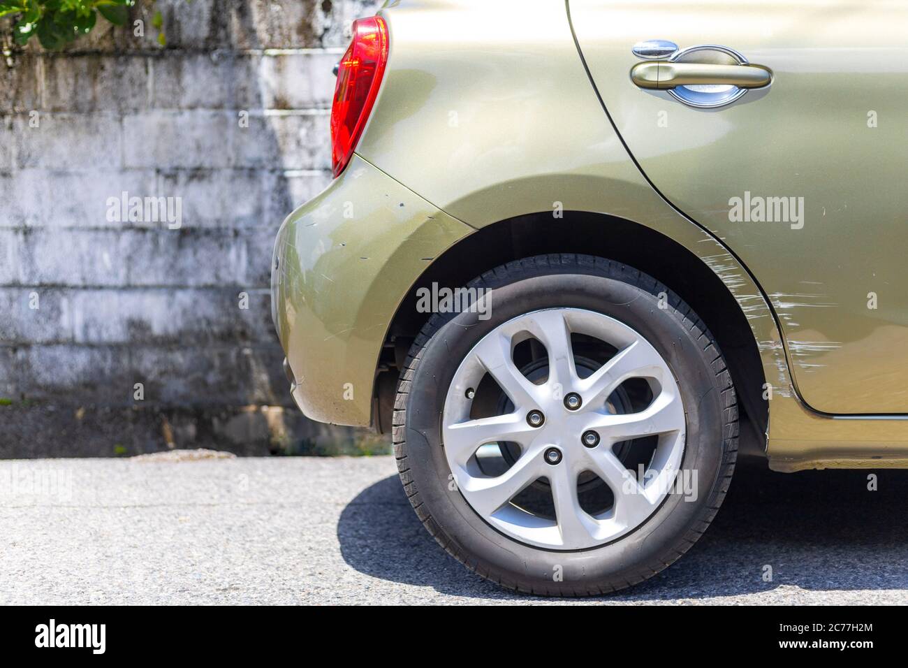 Car crash. Beside the deep green color car have scratch from damage on ...
