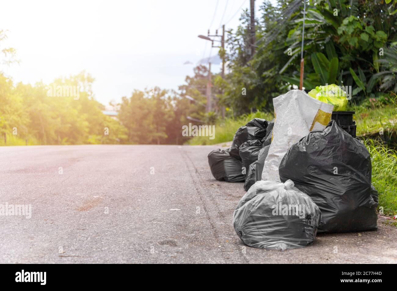 Big and many plastic garbage bag on streets with garbage sitting on ...