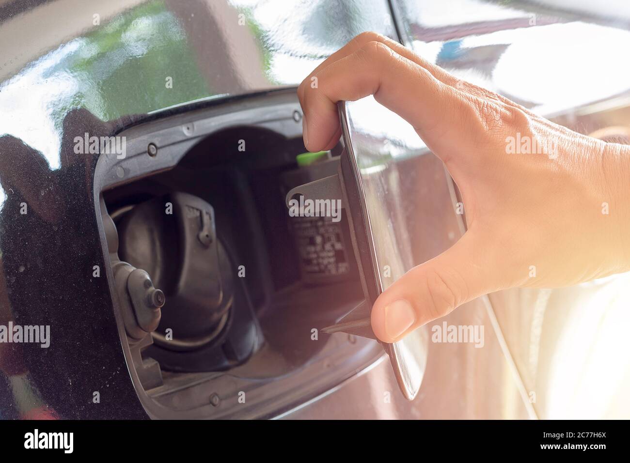 Close up hand man open the fuel tank cover in the car Stock Photo - Alamy