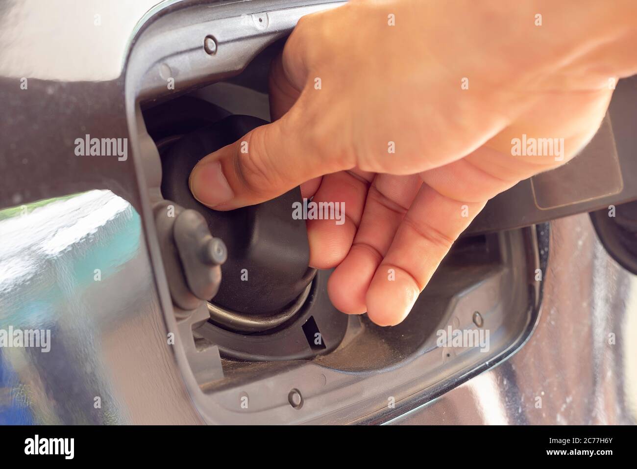 Close up Man hand open the gas tank and holds the gas tank cap Stock ...