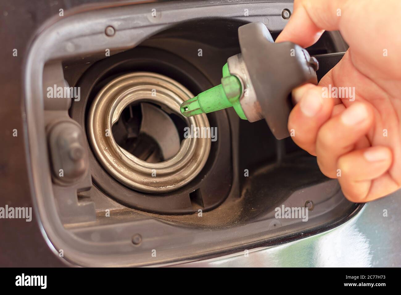 Close up Man hand open the gas tank and holds the gas tank cap Stock ...