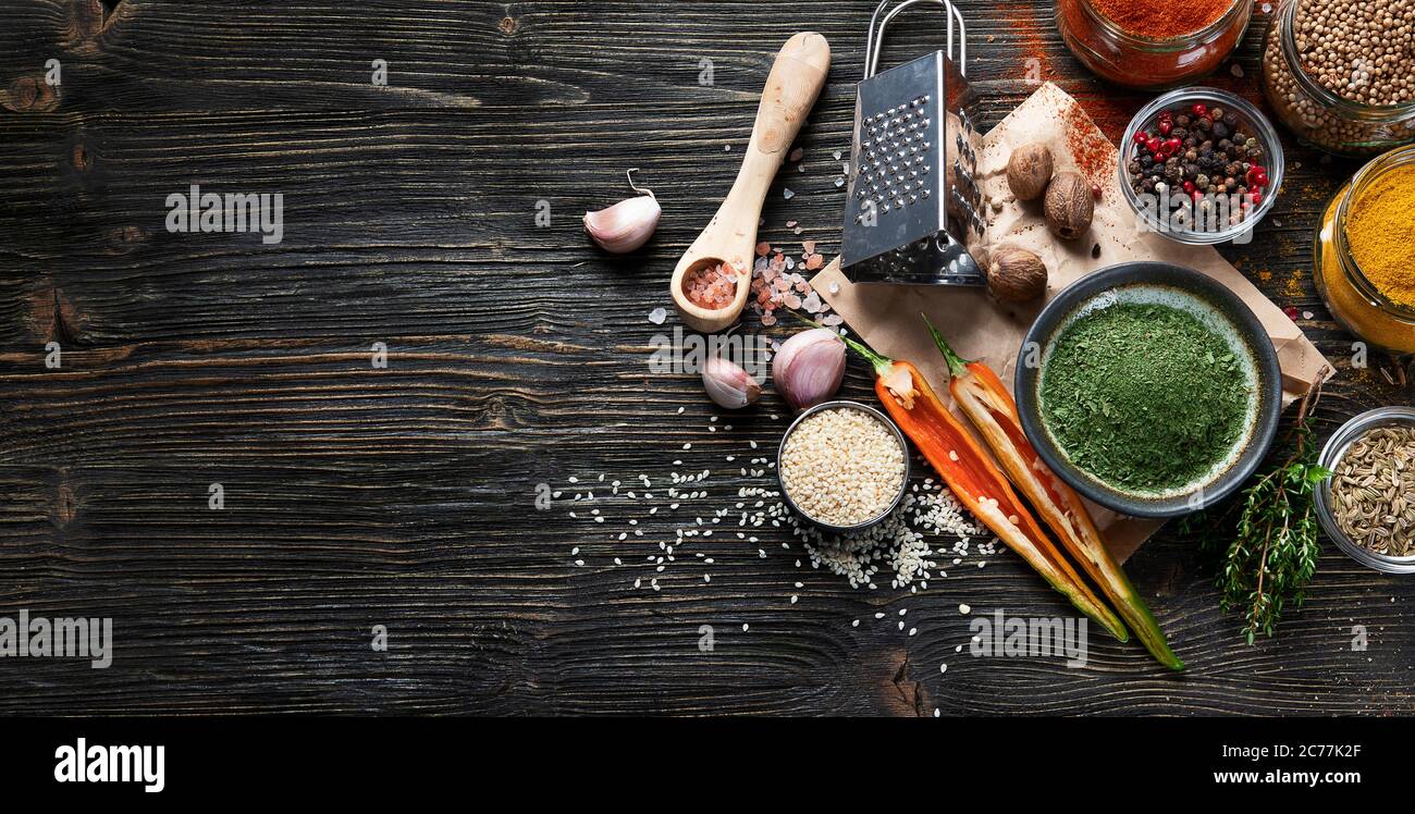 Various spices for cooking on rustic wooden background. Top view with ...