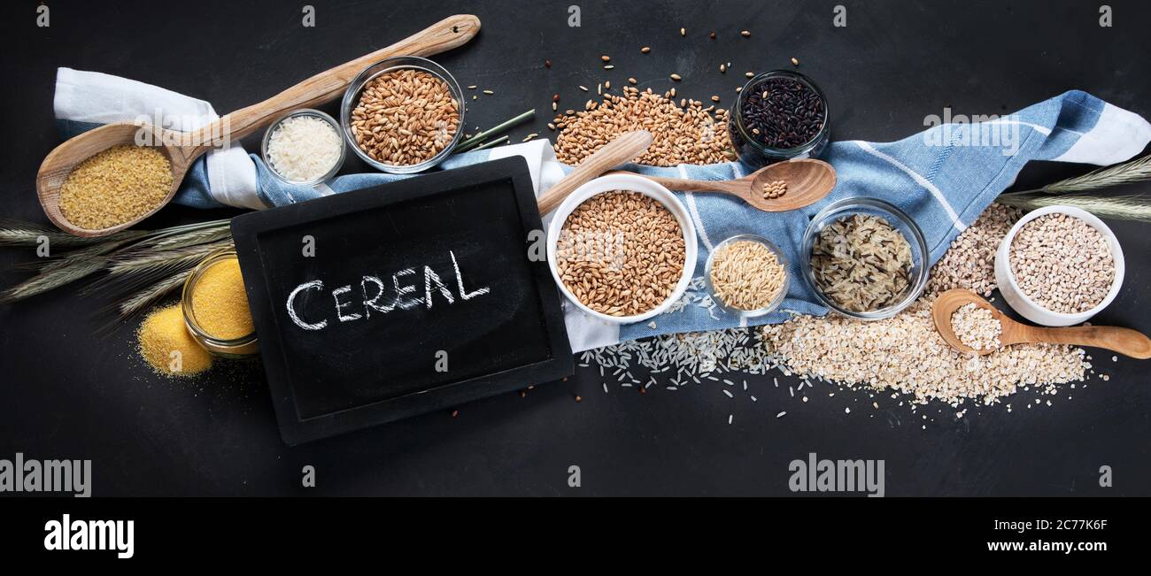 Different types of cereals in bowls on black background. Healthy ...