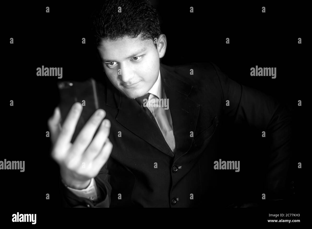 Portrait shot of a young businessman using technology in his business ...