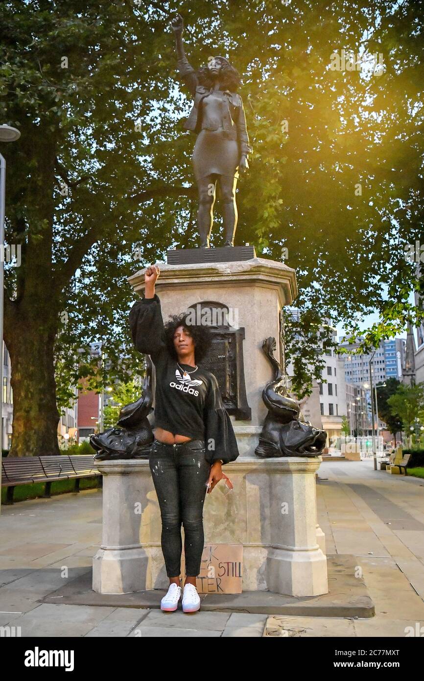 Jen Reid poses in front of her black resin and steel statue titled A ...