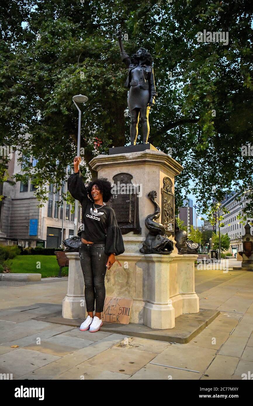 Jen Reid poses in front of her black resin and steel statue titled A ...