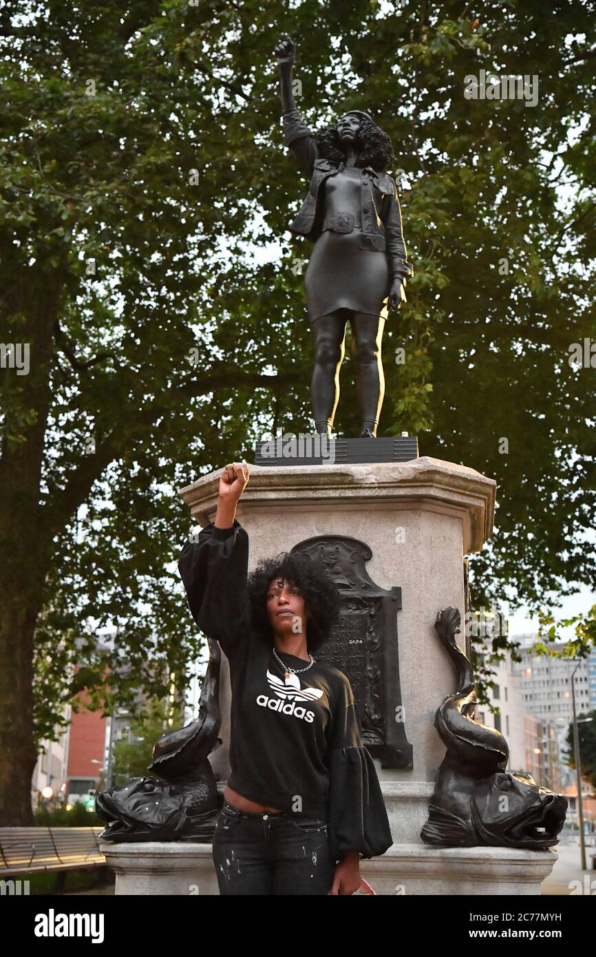 Jen Reid poses in front of her black resin and steel statue titled A ...