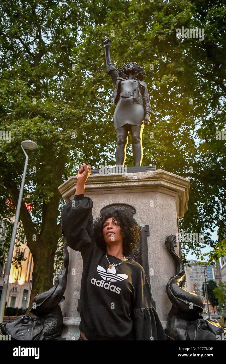 Jen Reid poses in front of her black resin and steel statue titled A ...